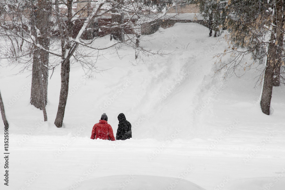 Two people at the base of the Buckley park sledding hill in Durango, CO ...
