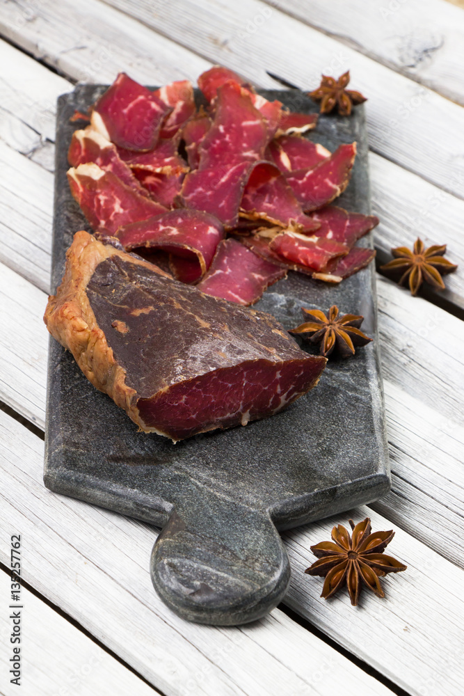 Whole-muscle cuts of meat are shaved into slices. Sliced smoked beef ...