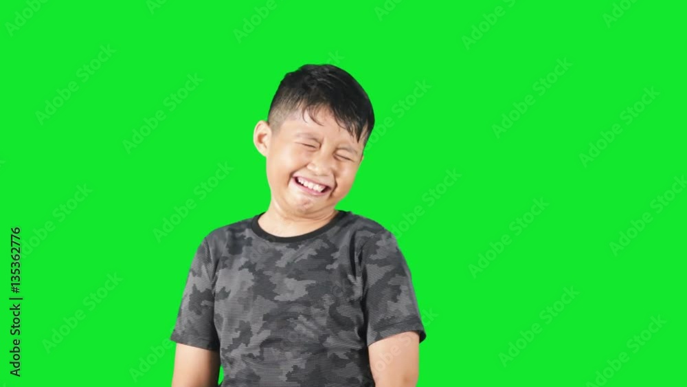 Little boy looks sad and crying alone in the studio while wiping his ...