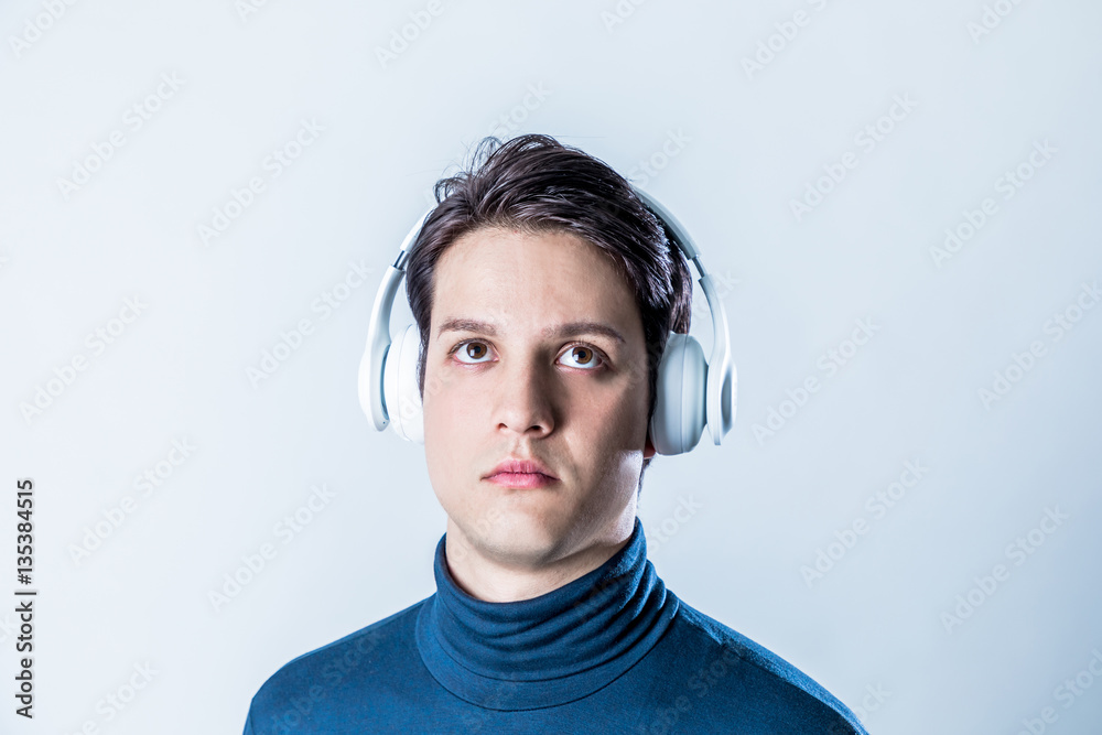 young man wearing wireless headphone and listening to music Stock Photo ...
