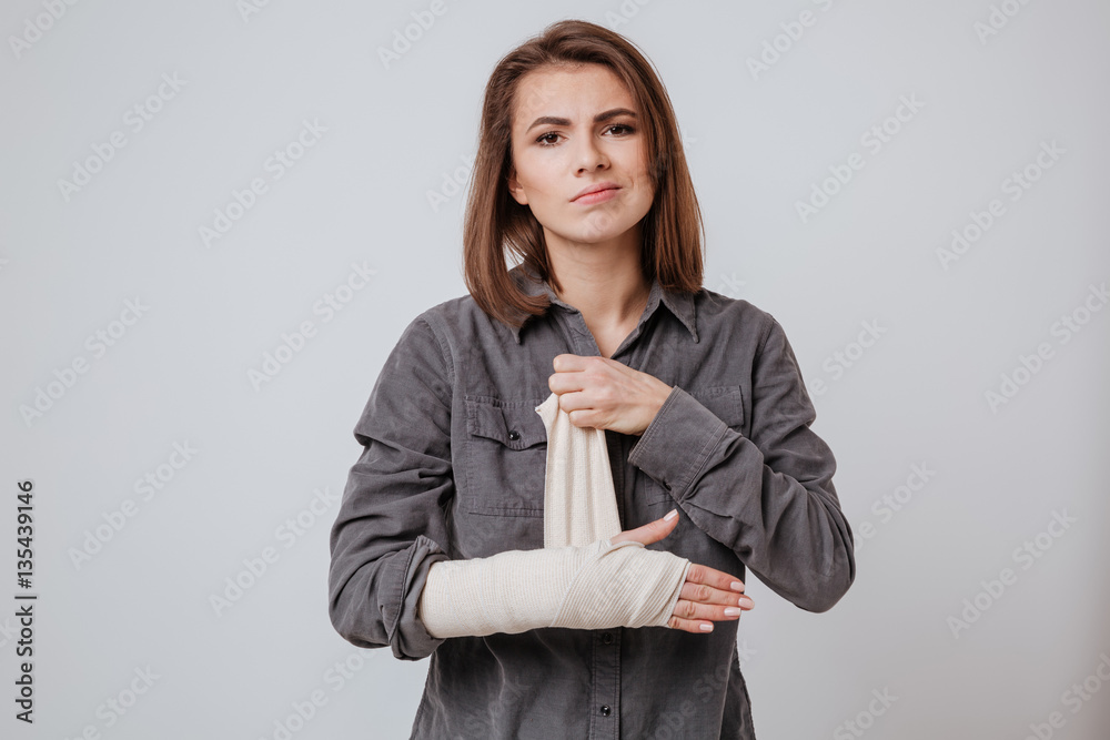 Sick young woman with the plaster on hand Stock Photo | Adobe Stock