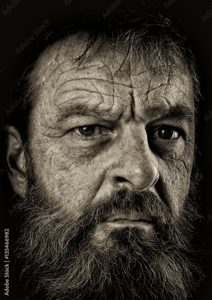 Studio portrait of fully bearded man in black and white. Closeup face ...