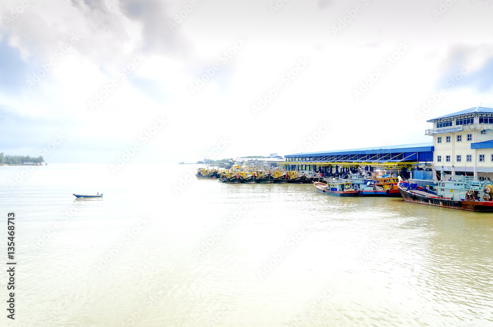 JOHOR, MALAYSIA - JANUARY 30, 2017: Fishing boats anchored at the jetty ...