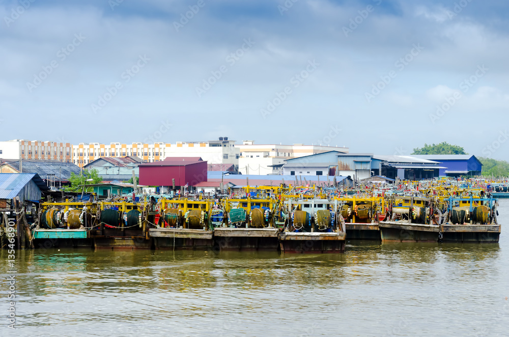 JOHOR, MALAYSIA - JANUARY 30, 2017: Fishing boats anchored at the jetty ...