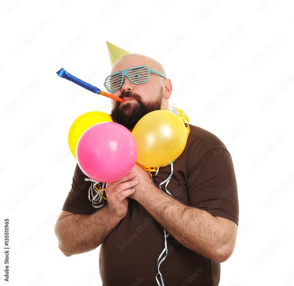Funny fat man with party blower and colorful balloons on white ...