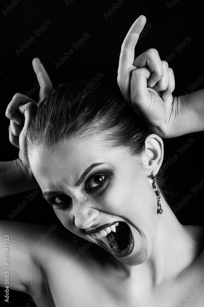 fun luxury woman vampire making devil horns screaming on black ...