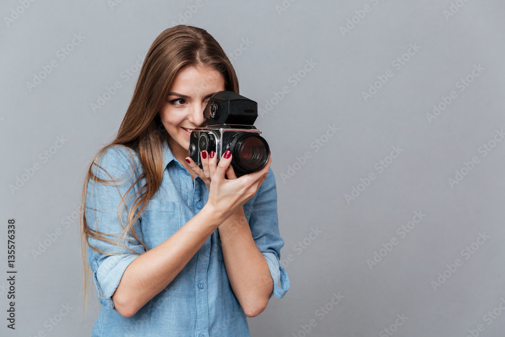 Woman in shirt using retro video camera Stock Photo | Adobe Stock