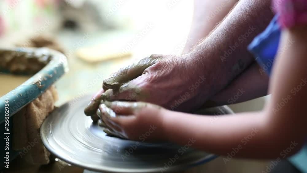 Senior potter teaching happy little girl the art of pottery. Child ...