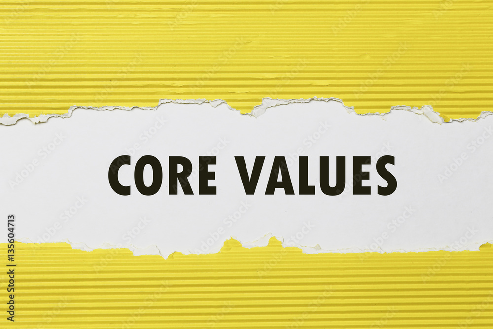 The word Core Values appearing behind torn paper. Stock Photo | Adobe Stock