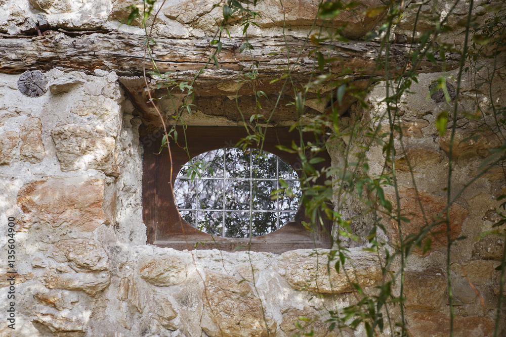 Small round window in stone facade Stock Photo | Adobe Stock