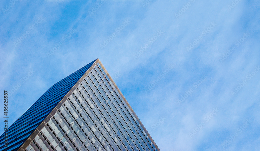 Image of office building triangle part with reflection of blue sky and ...