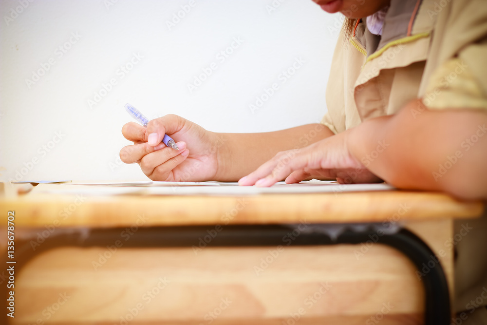 students writing on a paper for exams and admissions in high sch Stock ...