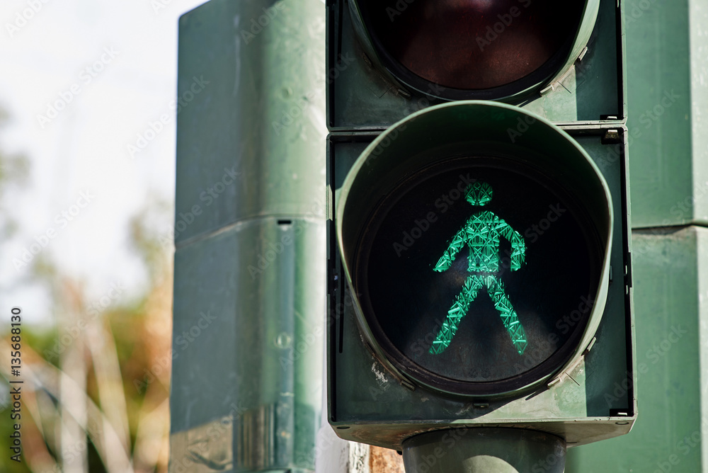 Traffic light with the green man sympol. Stock Photo | Adobe Stock