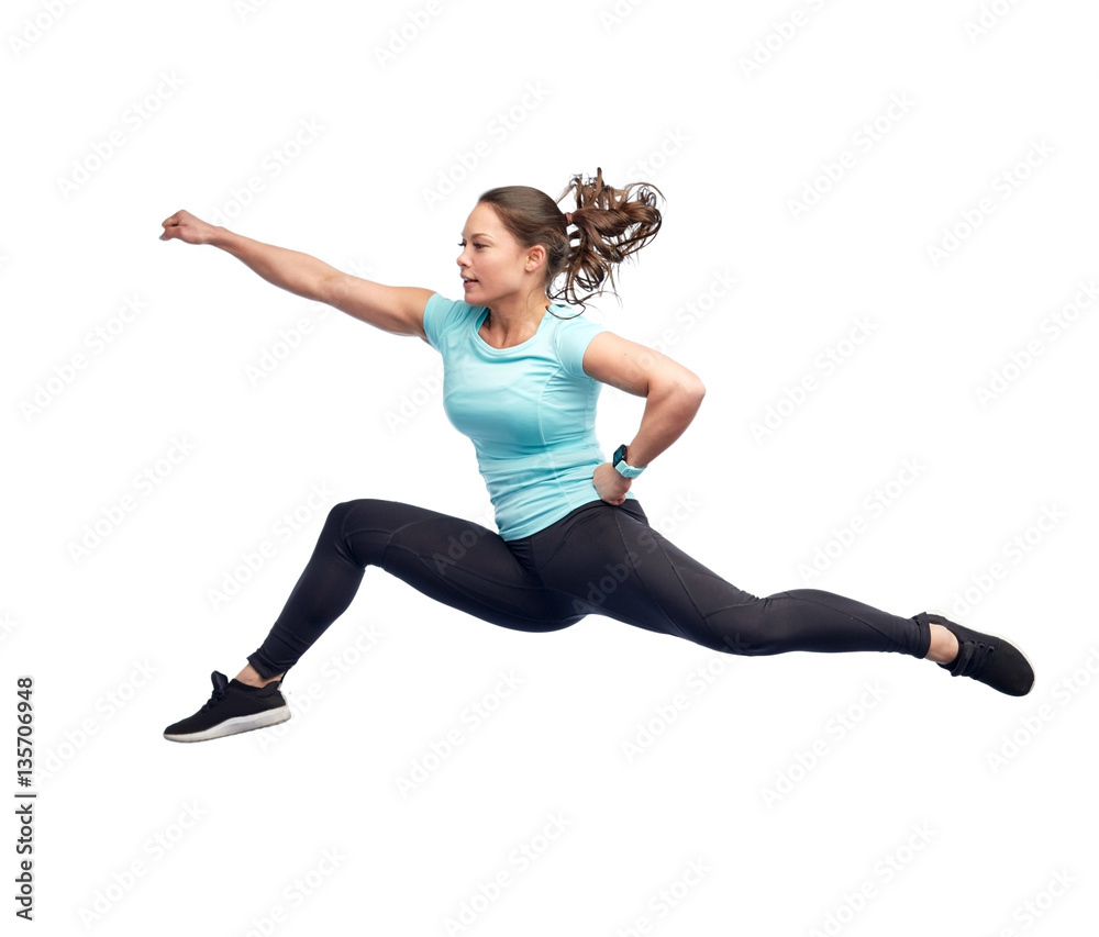 happy sporty young woman jumping in fighting pose Stock Photo | Adobe Stock