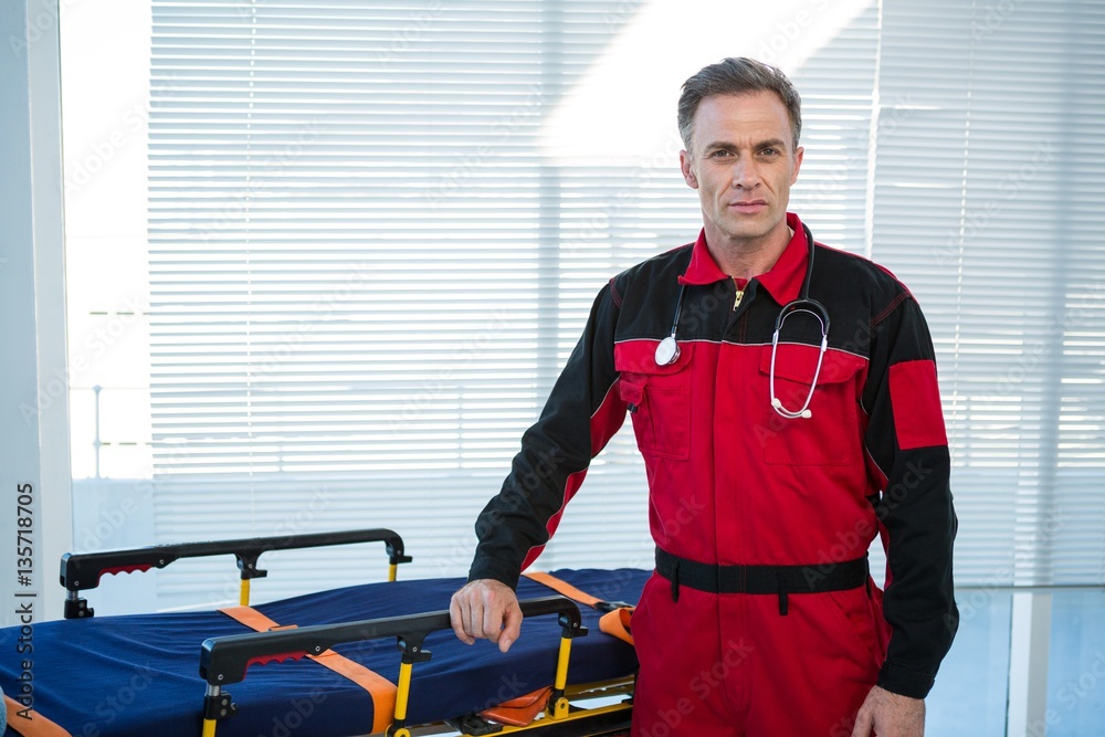 Paramedic standing beside a stretcher Stock Photo | Adobe Stock