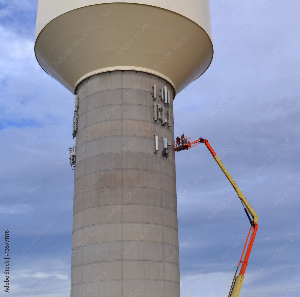 Installing cellular antennas on a water tower Stock Photo | Adobe Stock