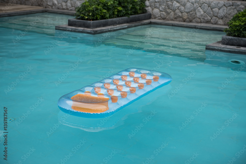Inflatable Lilo Air Bed in a swimming pool. Floating In Swimming Pool ...