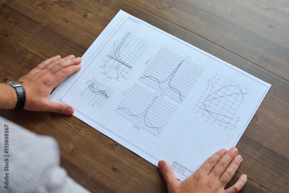 Mechanical engineer at work. Technical drawings. Paper with technical ...