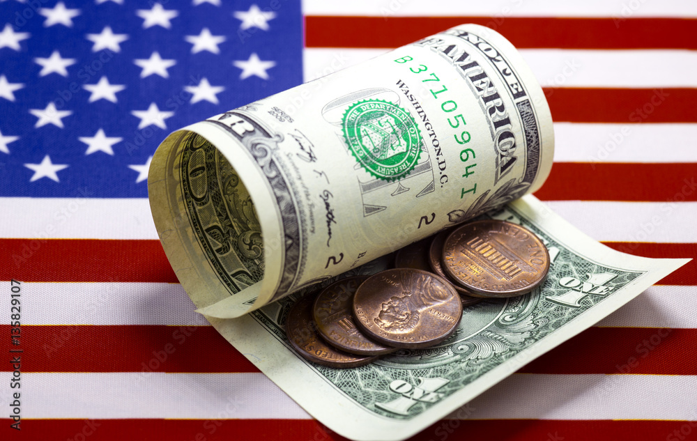 US cash money. US flag as a background. One American dollar bill and ...