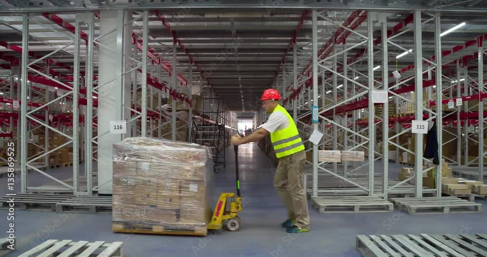 Warehouse worker transports boxes on trolley loader 4k video. Delivery ...