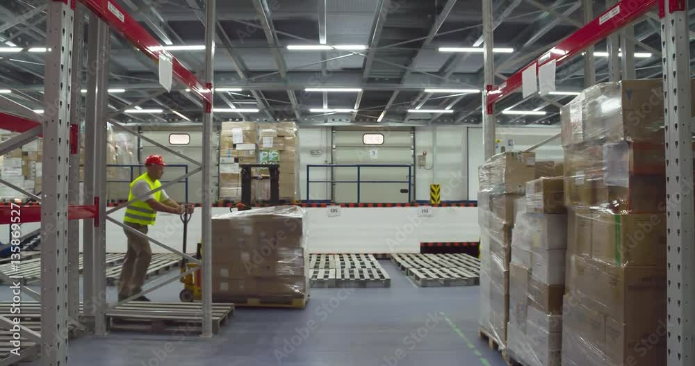 Warehouse worker transports boxes on trolley loader 4k video. Delivery ...