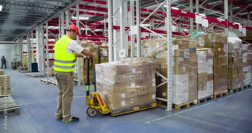Warehouse worker transports boxes on trolley loader 4k video. Delivery ...