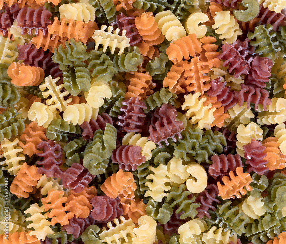 Colorful food background of raw twisted pasta Stock Photo | Adobe Stock