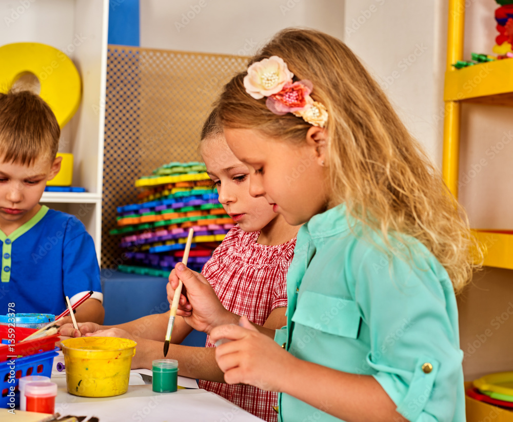 Small students painting in art school class. Child drawing by paints on ...
