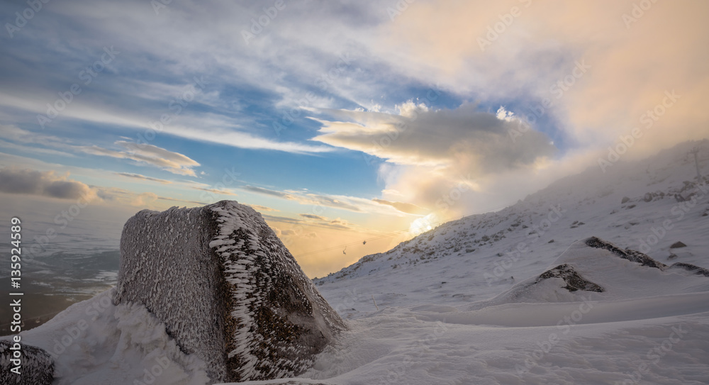 Sun rising behind behind frozen peaks - beautiful winter landscape on a ...