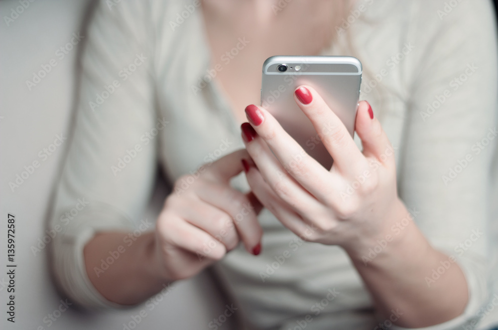 Female hands with red nails holding smart phone Stock Photo | Adobe Stock