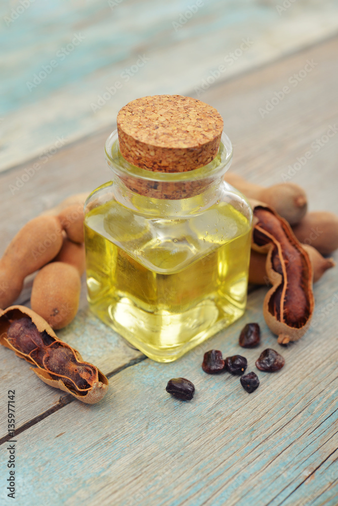 Essential tamarind oil with tamarind pods Stock Photo | Adobe Stock