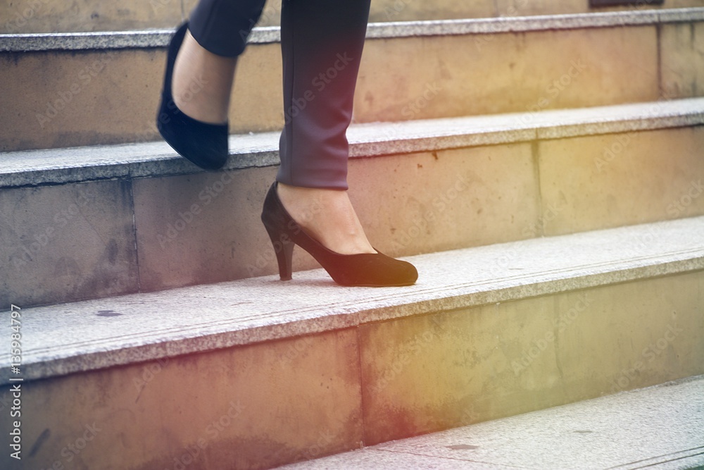 focus woman feet walking down stairs. Stock Photo | Adobe Stock