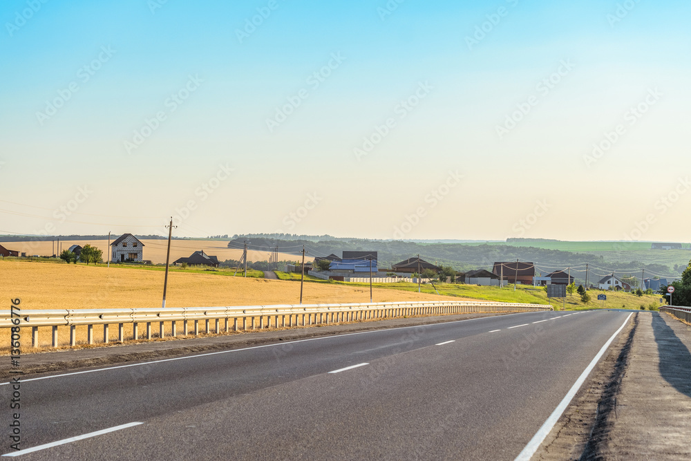 Rural asphalt road with markings and guard rail. Belgorod region ...