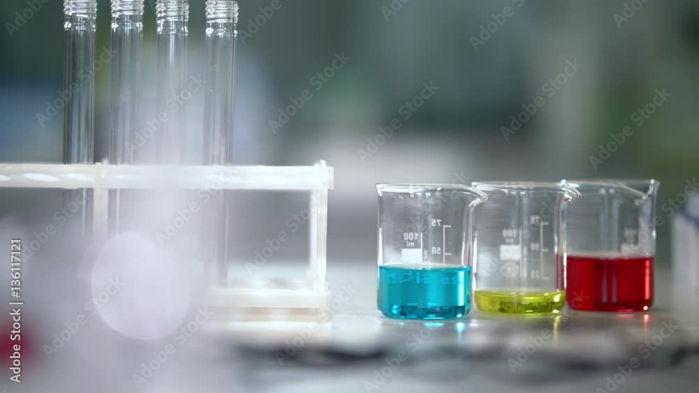 Lab worker put test tubes rack on laboratory table. Closeup of ...