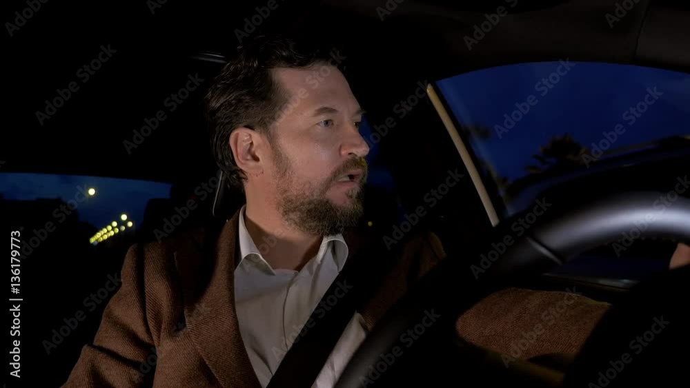 Man in car at night trying to get out of parking getting angry/Man ...