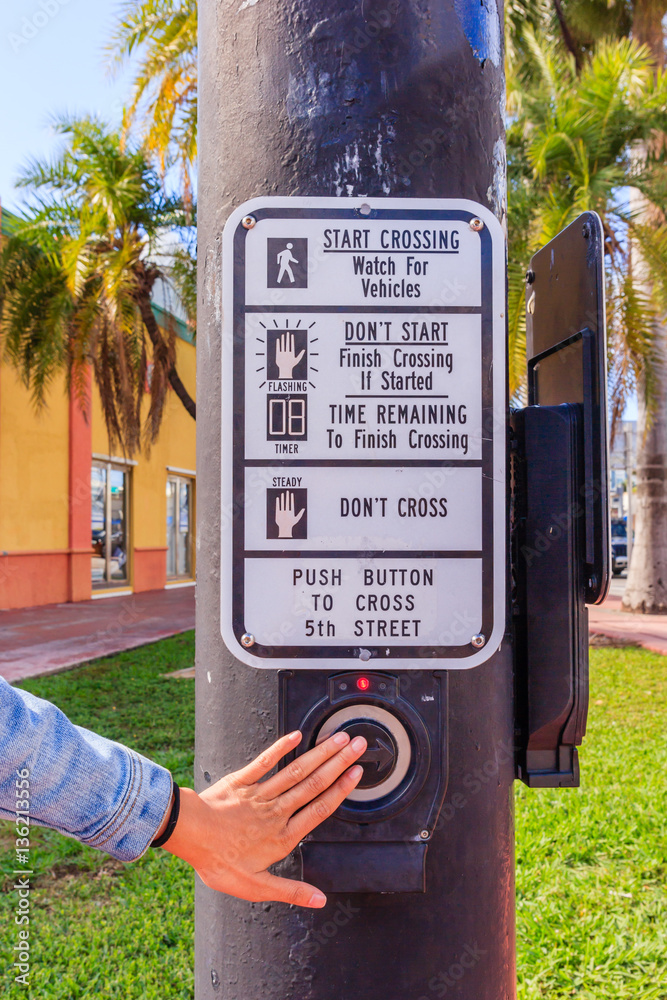 Young man hand pushing button for traffic light. Use traffic lights at ...