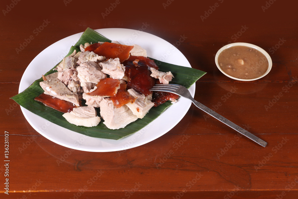 Lechon or suckling pig chopped and place on a banana leaf together with ...
