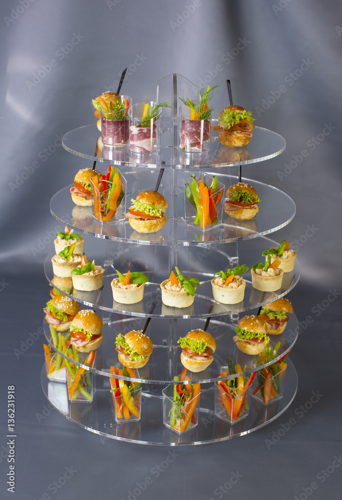 Mini desserts and meat canapes vegetable snacks in plastic cups canapes ...