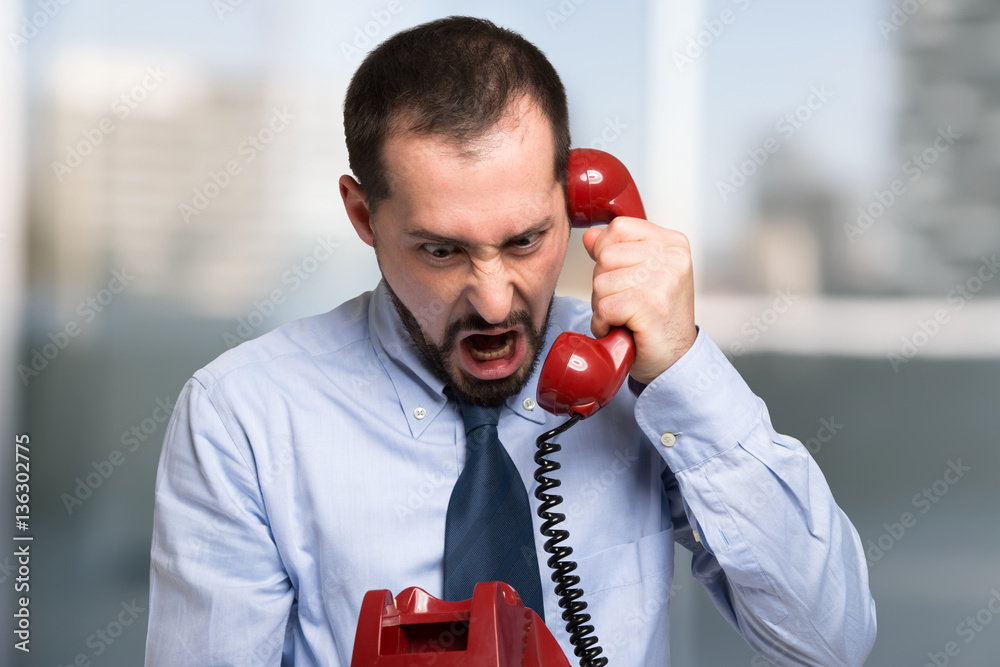 Angry businessman yelling on the phone Stock Photo | Adobe Stock