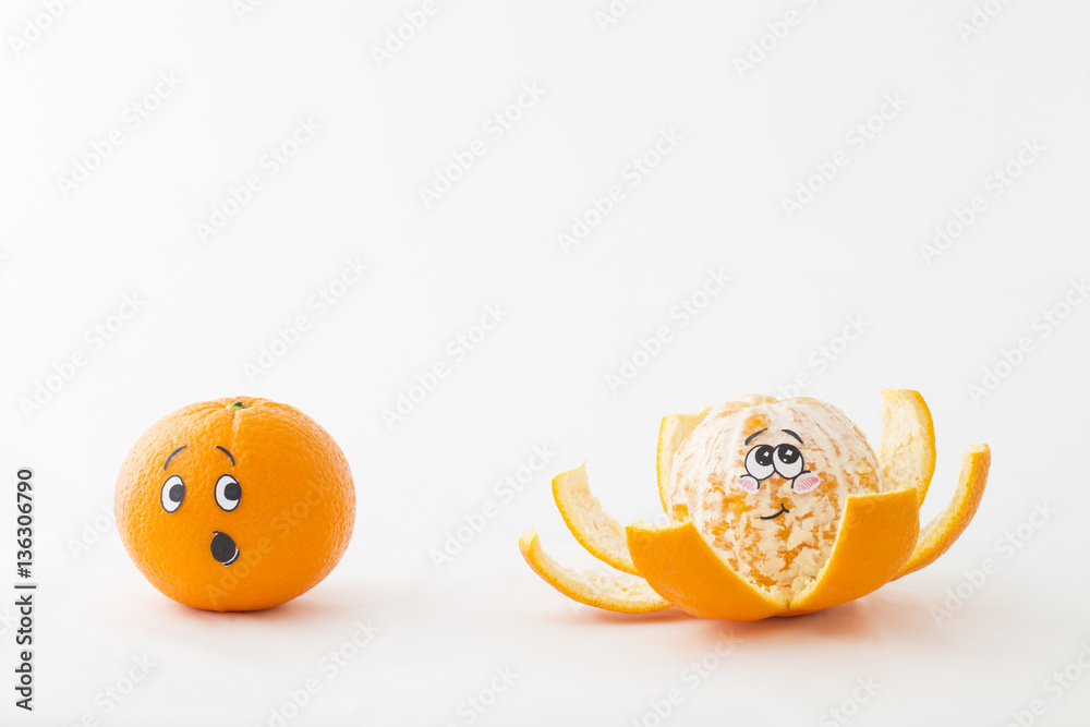 One tangerine with an astonished face and a peeled tangerine with ...