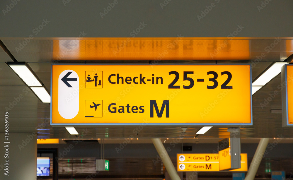 Illuminated sign with gate number and check-in desks Stock Photo ...