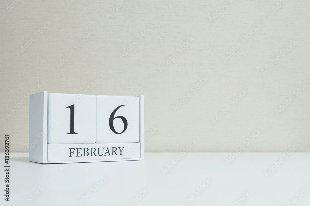 Closeup white wooden calendar with black 16 february word on blurred ...