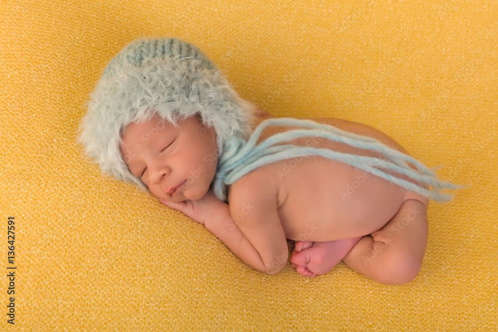 Sleepy baby with eskimo hat Stock Photo | Adobe Stock