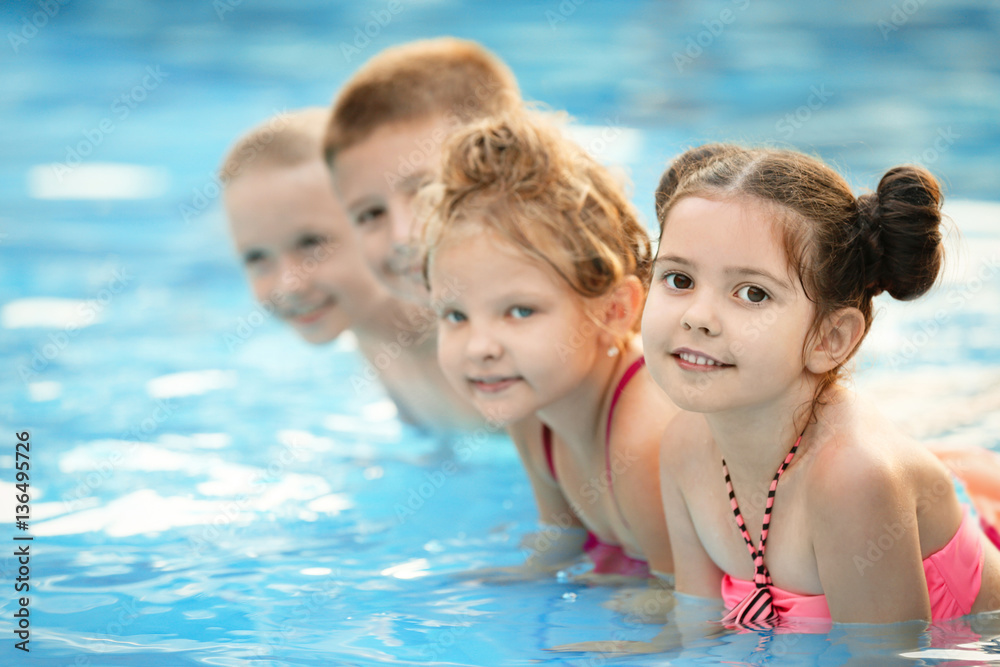 Little kids in swimming pool on sunny day Stock Photo | Adobe Stock