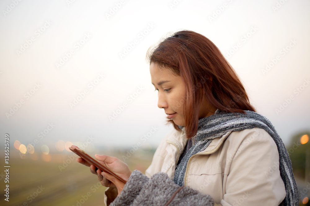 beautiful asian woman looking on smart phone Stock Photo | Adobe Stock