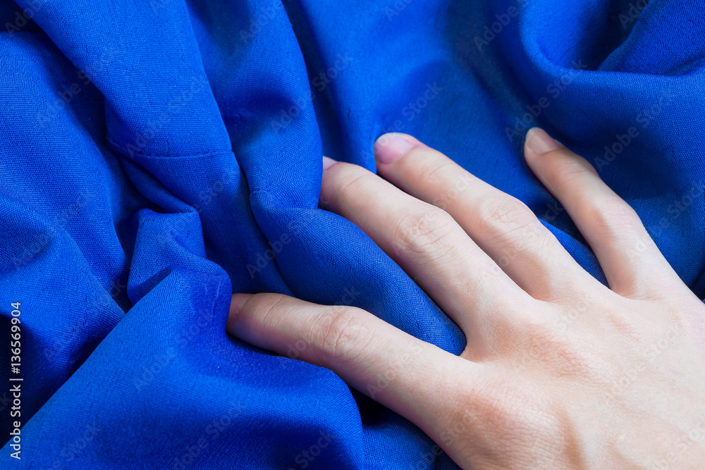 hand holding on crumpled blue fabric cloth Stock Photo | Adobe Stock