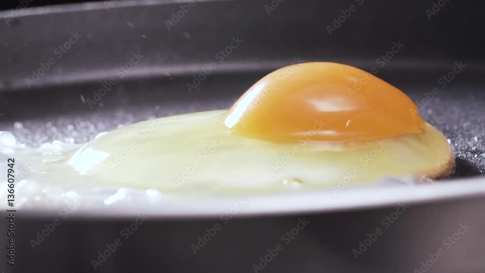 Video of egg being dropped on hot pan Stock Video | Adobe Stock