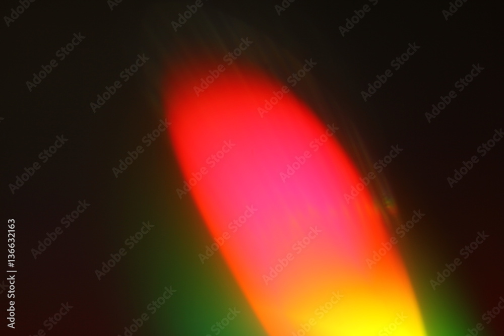 Abstract background - light color flashes and rays on black. Lens flare ...