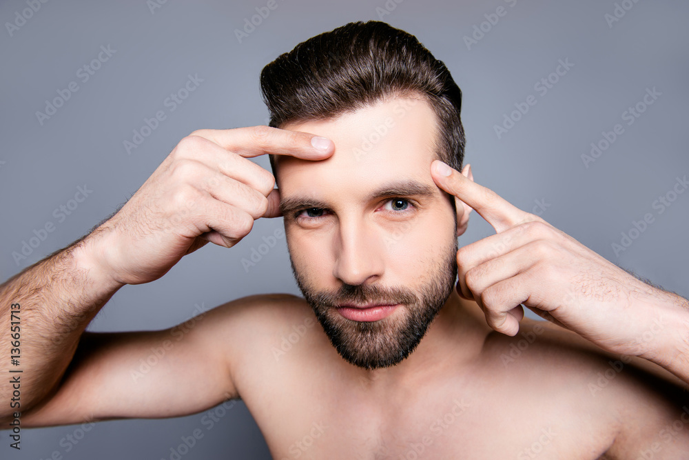 Portrait of young man looking for acnes on his face Stock Photo | Adobe ...