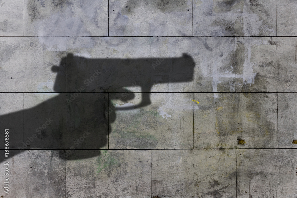 dark shadow of a hand holding a gun Stock Photo | Adobe Stock